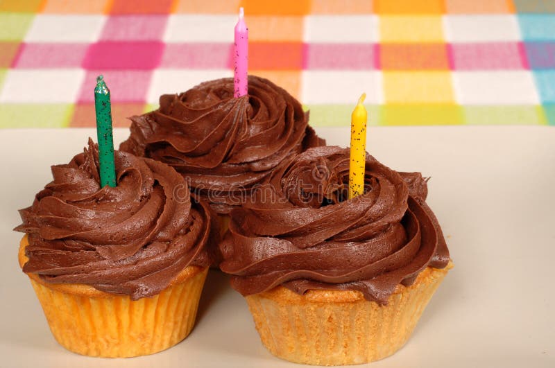 Three Chocolate Frosted Cupcakes With Candles Picture. Image: 1773248