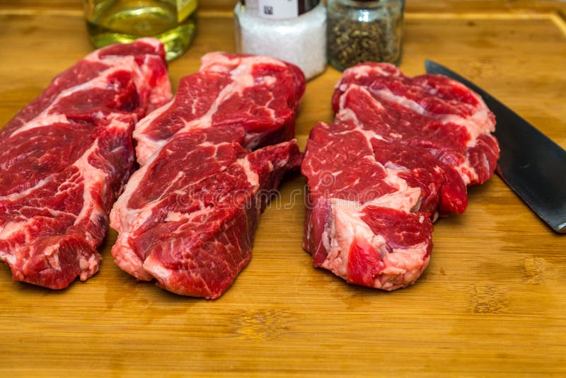Three Chuck Steaks on Cutting Board Stock Image - Image of beef, roll ...