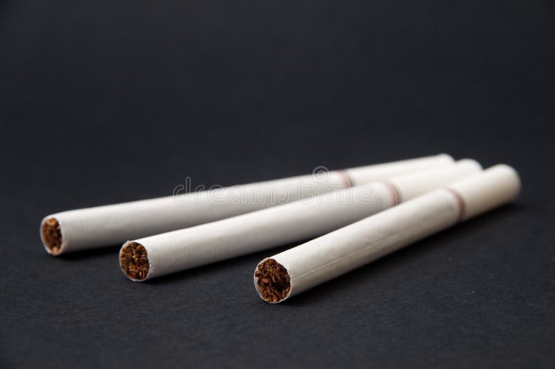 Three cigarettes on beach stock image. Image of trash - 10204177