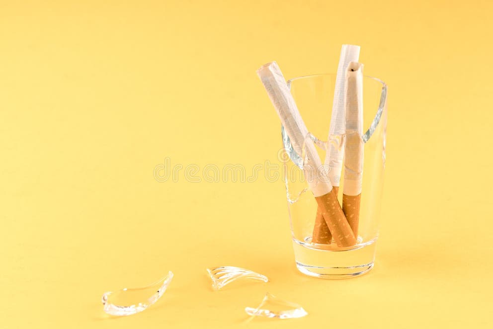 Three Cigarettes, Filter Down, are Stacked in a Glass Beaker Stock ...