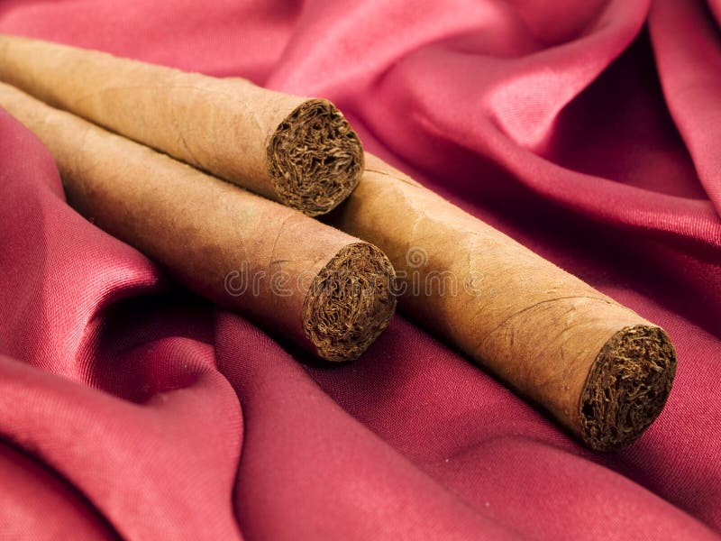 Three Cigars on red satin stock image. Image of cuba - 58616957
