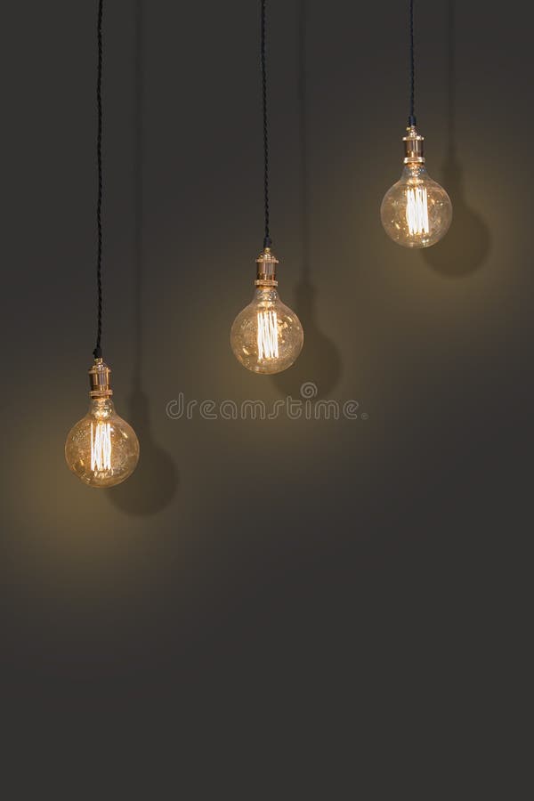 Three Classic Edison Lights Bulb Isolated on Black Background with ...