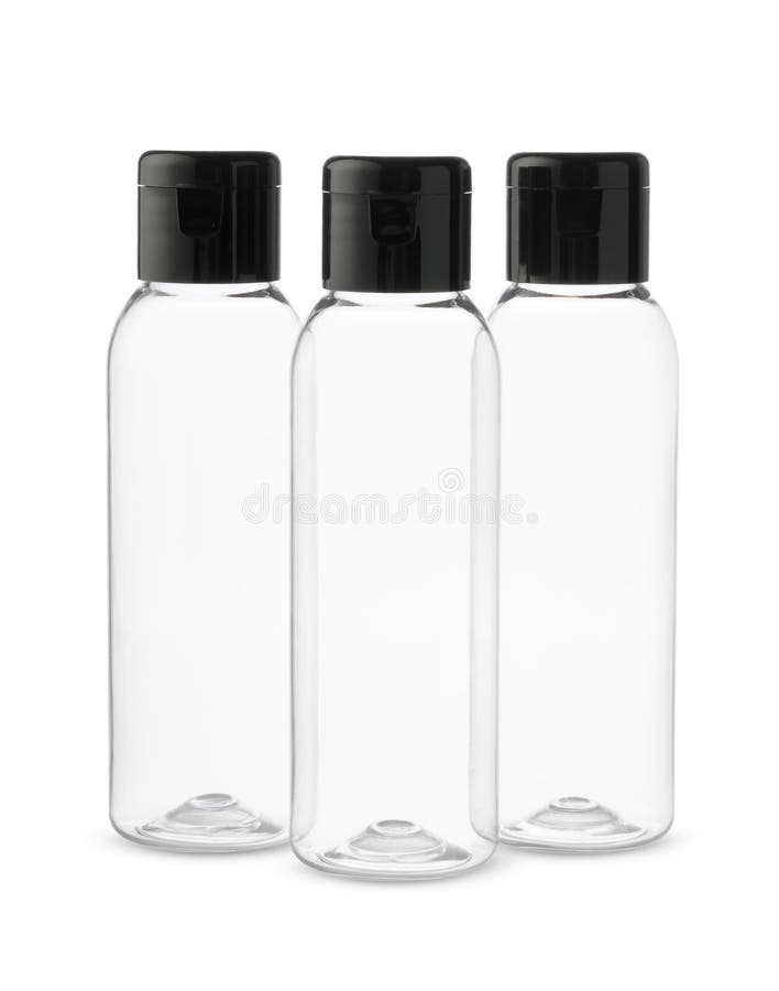 Three Clear Plastic Bottles with Black Caps on a White Background Stock ...