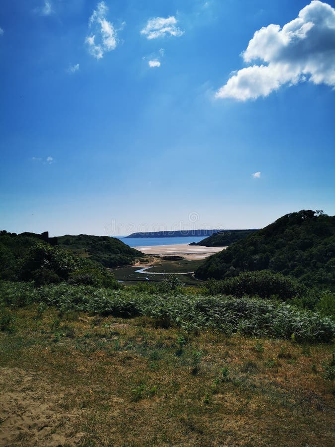 Three Cliffs Beach stock image. Image of clouds, nature - 186099413