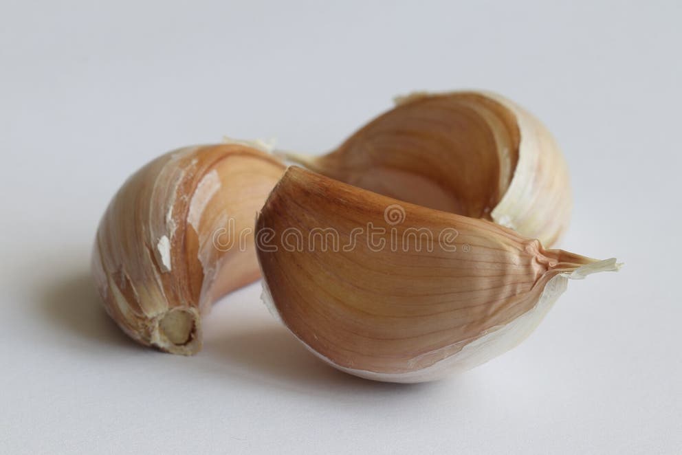 Three cloves of garlic. stock photo. Image of background - 212499406