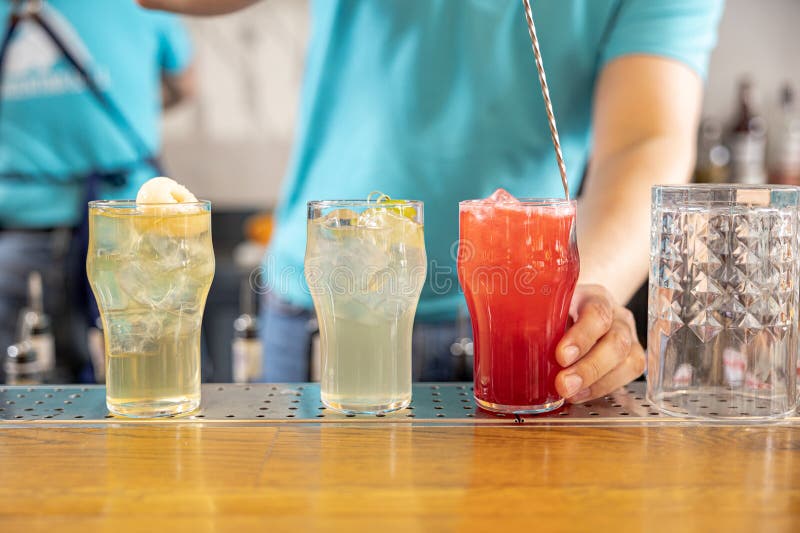 Three Cocktails in Rocks Glasses on the Edge of a Bar with the ...