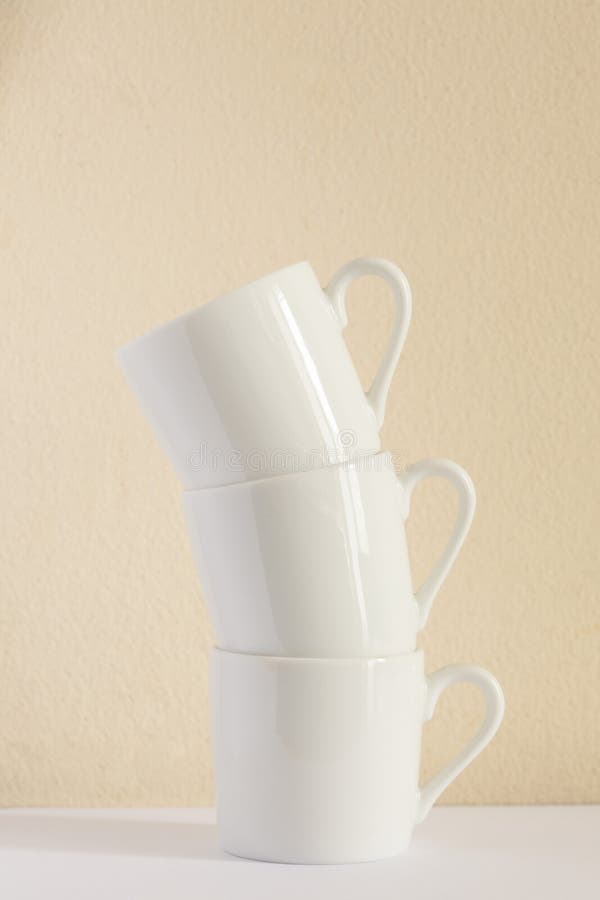 Three Coffee Cups Piled on a Table Stock Photo - Image of wall, cups ...