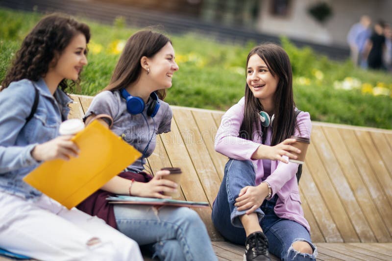 Three Collage Girls Studying Outside Stock Image - Image of headphones ...