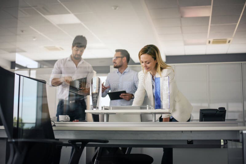 Three Colleague in Office Using Computer and Checking Document. Stock ...