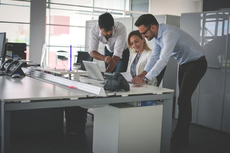Three Colleague in Office Using Computer and Checking Document. Stock ...