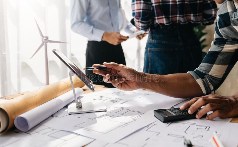 Three Colleagues Discussing Data Working and Tablet, Laptop with on on ...