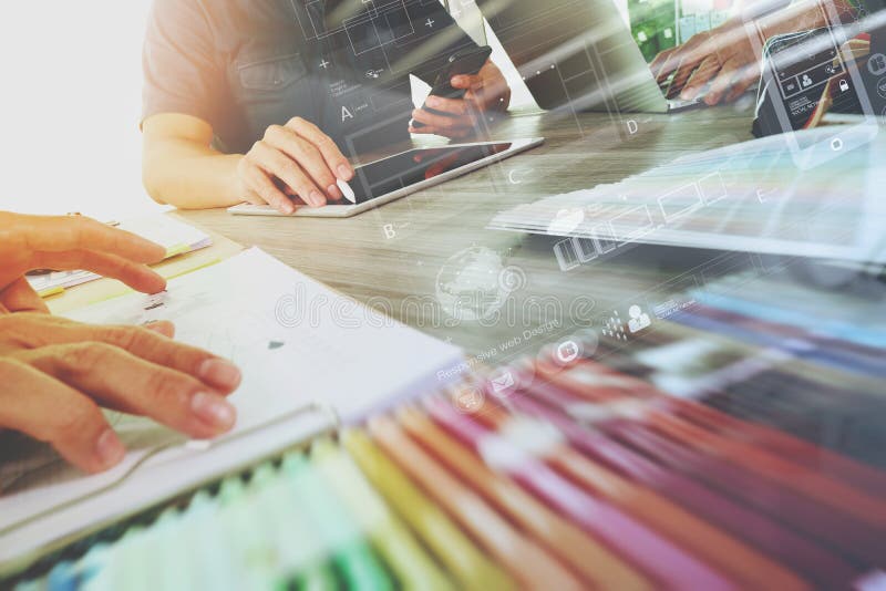 Three Colleagues Interior Designers Discussing Data with Digital Stock ...