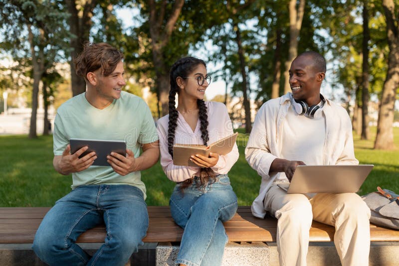 Three College Classmates Preparing for Lecture Together, Sitting on ...