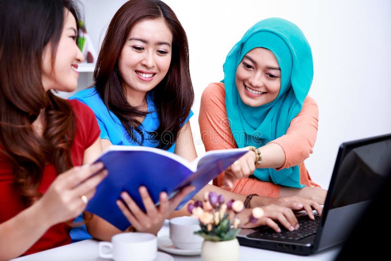 Three College Students Discussing about Their Lecture Subject Stock ...