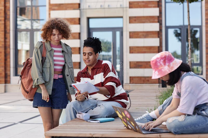 Three College Students Doing Homework Together Outdoors Stock Photo ...