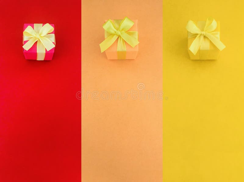 Three Colour Gift Boxes with a Yellow Satin Ribbon Bow on Their Same ...