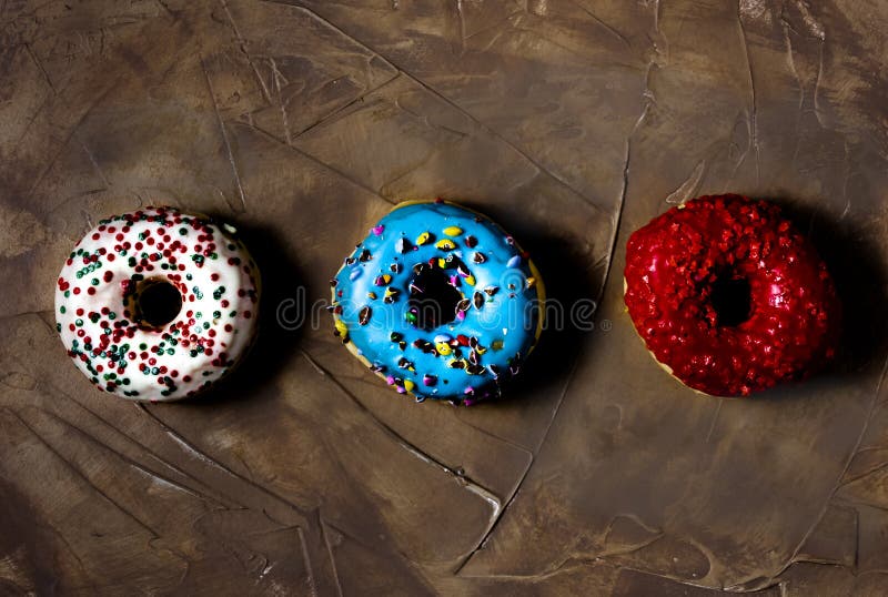 Three colored donuts stock image. Image of donuts, brown - 140583421