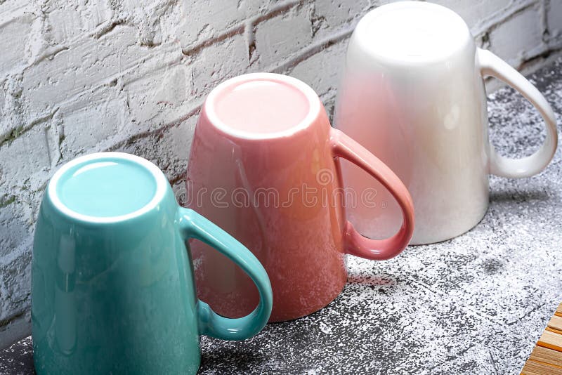 Three Colored Mugs are on the Kitchen Table. Stock Photo - Image of ...