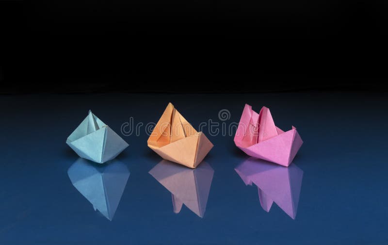 Three colored paper boats stock image. Image of sailing - 67288909