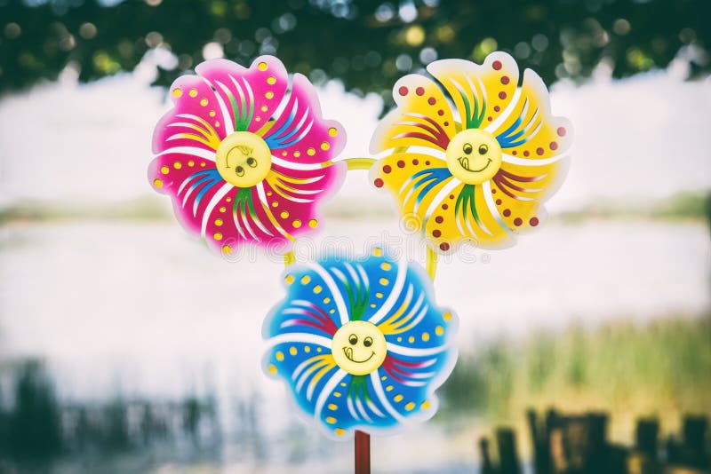 Three colored pinwheels stock photo. Image of childhood - 78726726