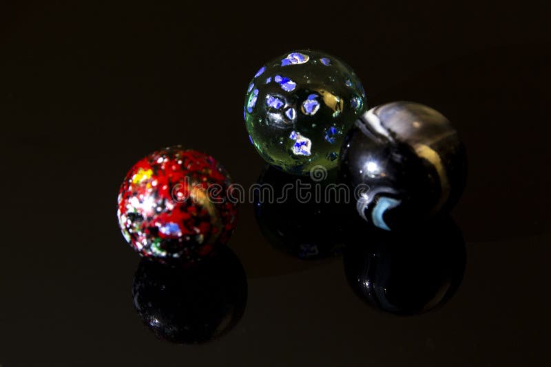 Three Colorful Marbles in a Closeup Photography Stock Image - Image of ...