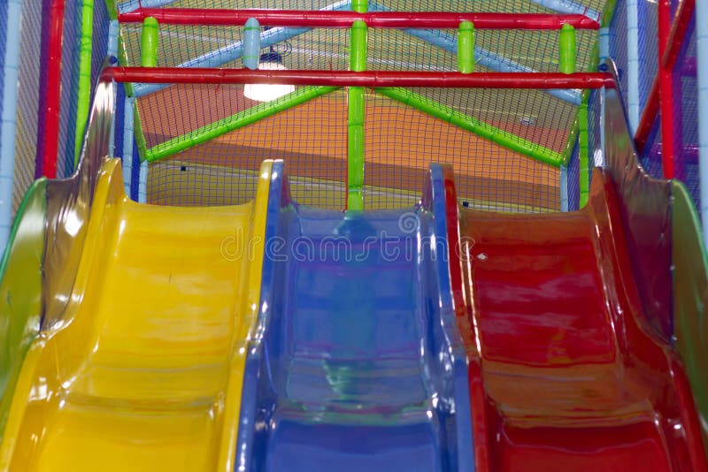 Three Colorful Slides for Children in Play Center Stock Image - Image ...