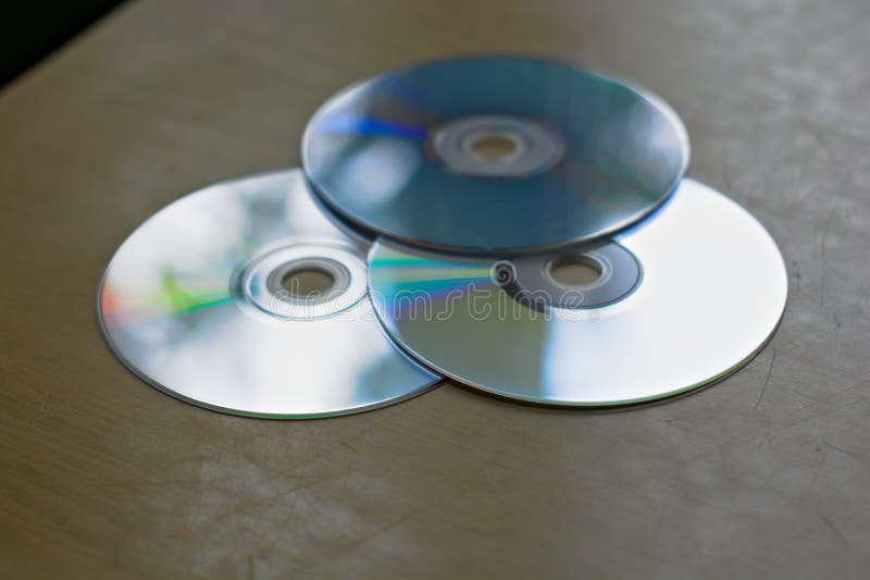 Three Compact Discs on the Desk Stock Photo - Image of design, media ...