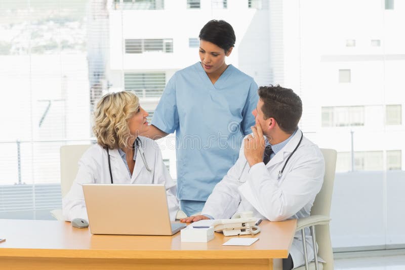 Doctors in Discussion with Patient in Medical Office Stock Image ...