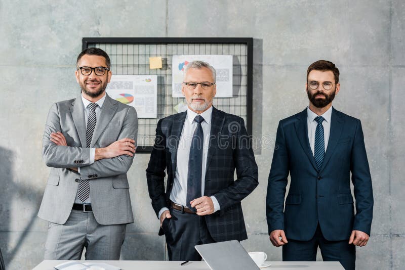 Three Confident Professional Businessmen Standing Together and Looking ...