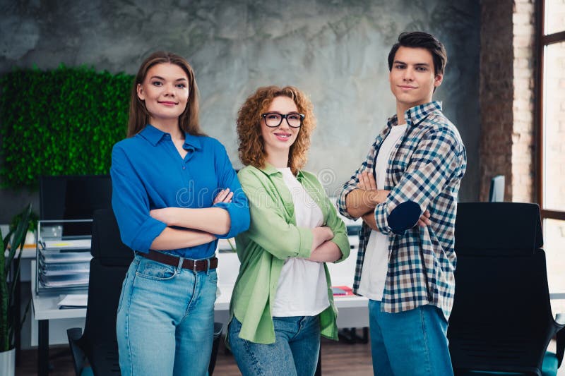 Three Confident Young Professionals Standing in a Bright Office ...