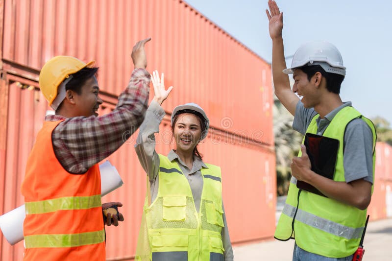 Construction Team Celebrating Success with High-fives Near Shipping ...