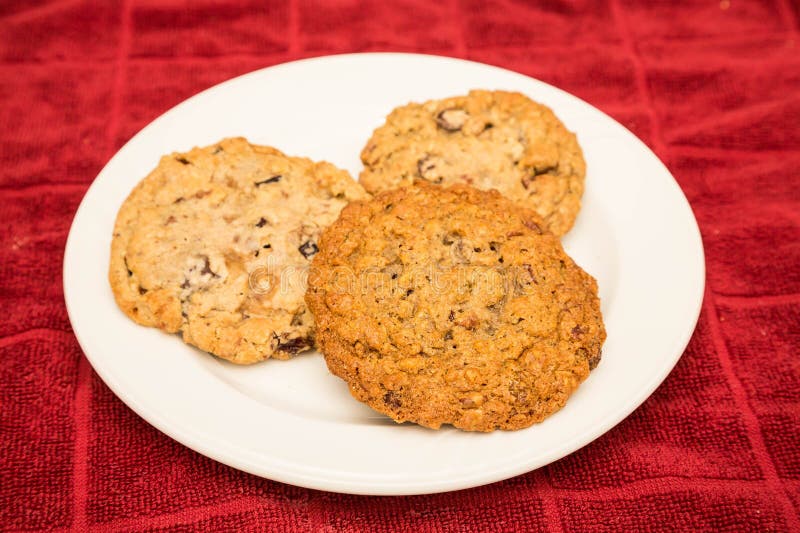 Three Cookies on White Plate and Red Towel Stock Image - Image of ...