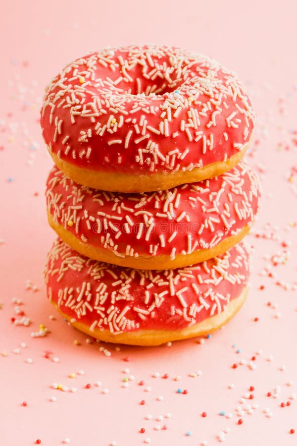 Three Coral Donuts Standing in a Line. Donuts with Icing Stock Photo ...