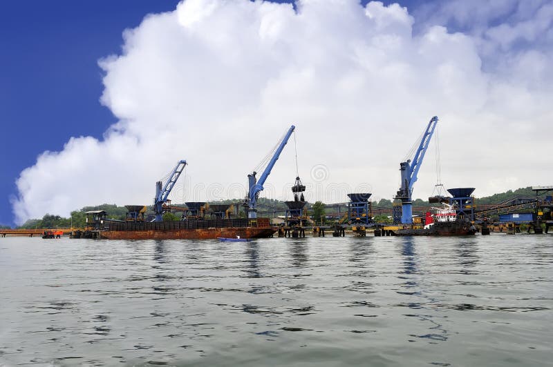 Three Crane Unloading Coal from Barge To Hopper Stock Image - Image of ...