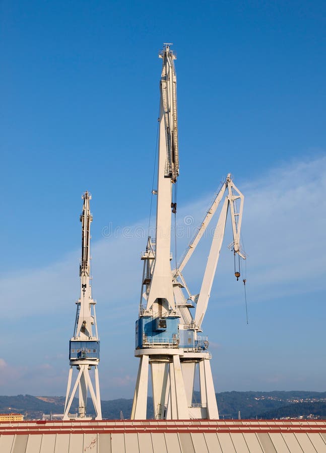 Three cranes in a shipyard stock image. Image of carrier - 31069927