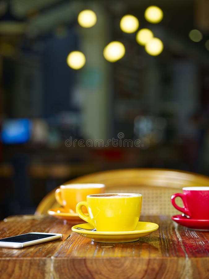 Cups of Coffee and Cellphone on Table Stock Image - Image of coffee ...
