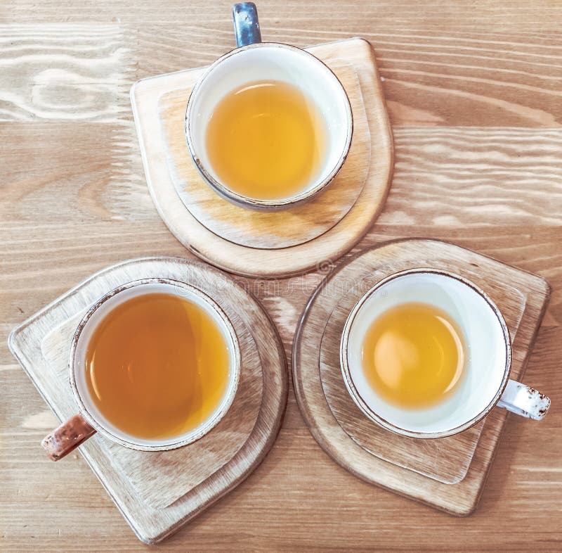 Three Cups with Tea on the Stand Stock Image - Image of wood, unity ...
