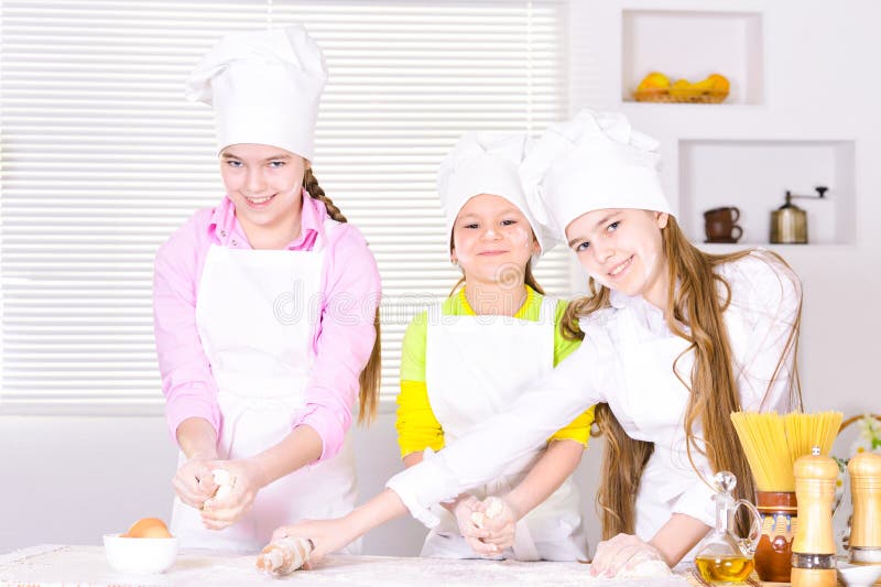 Three cute girls cooking stock image. Image of girls - 116200263