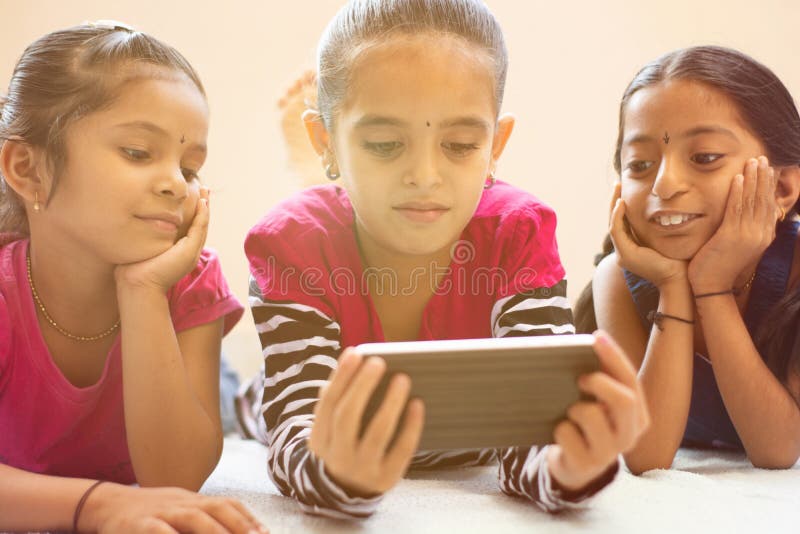 Three Cute Indian Children Watching Child Using Smartphone with Smiley ...