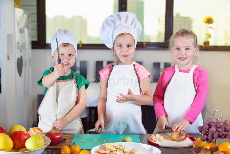 Three Cute Kids are Preparing a Fruit Salad in Kitchen Stock Photo ...