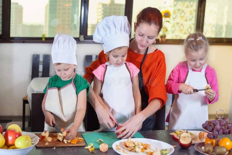 Three Cute Kids are Preparing a Fruit Salad in Kitchen Stock Photo ...