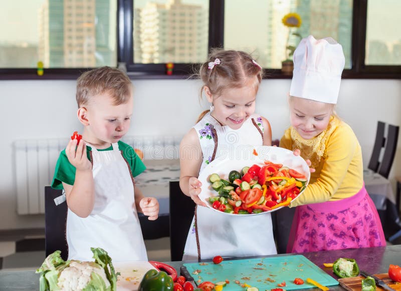 Three Cute Kids are Preparing a Salad in the Kitchen Stock Photo ...