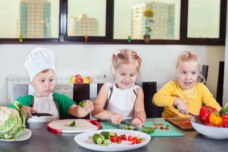 Three Cute Kids are Preparing a Salad in the Kitchen Stock Photo ...