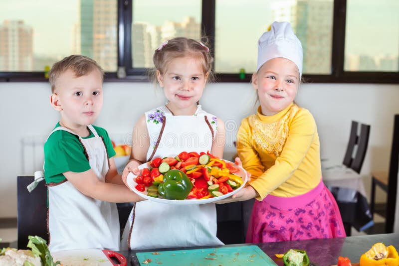 Three Cute Kids are Preparing a Salad in the Kitchen Stock Photo ...