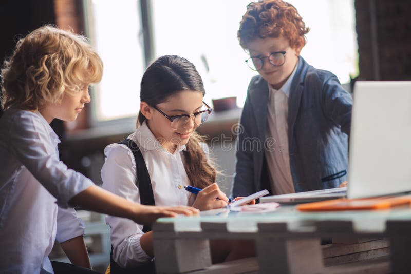 Three Cute Kids Working on Lessons Together and Looking Involved Stock ...