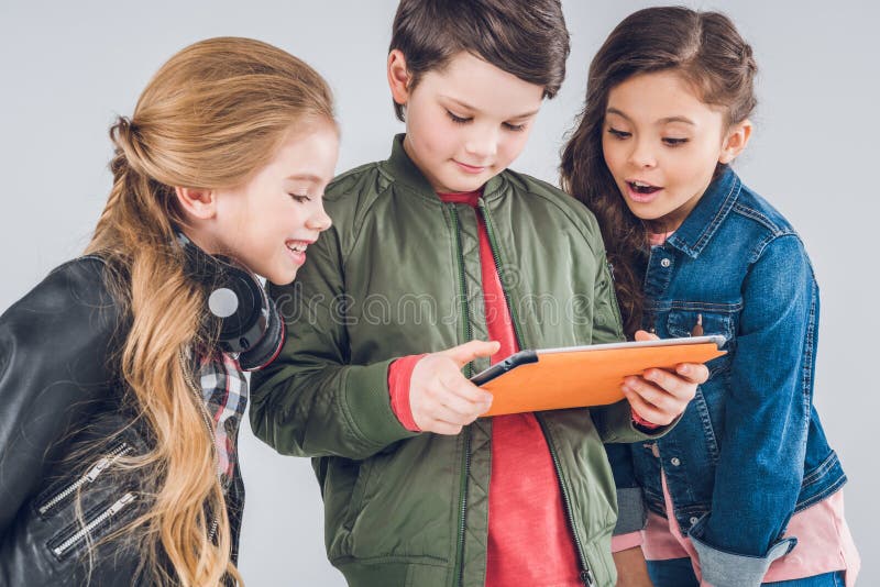 Three Cute Little Kids Using Digital Tablet Together Stock Image ...