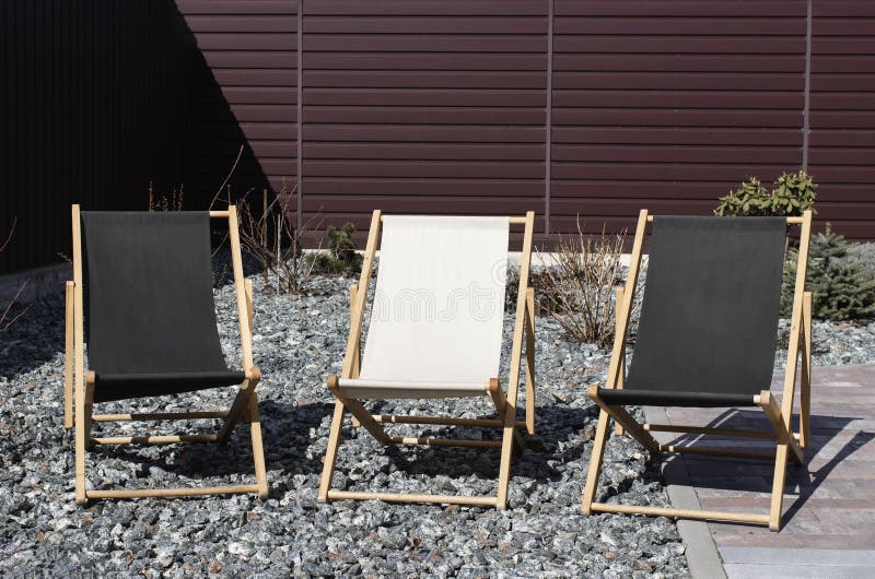 Three Deck Chairs Stand in the Yard. Recreation Area Stock Photo ...