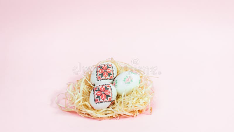Three Decorated Easter Eggs in a Nest on a Pink Background Stock Image ...