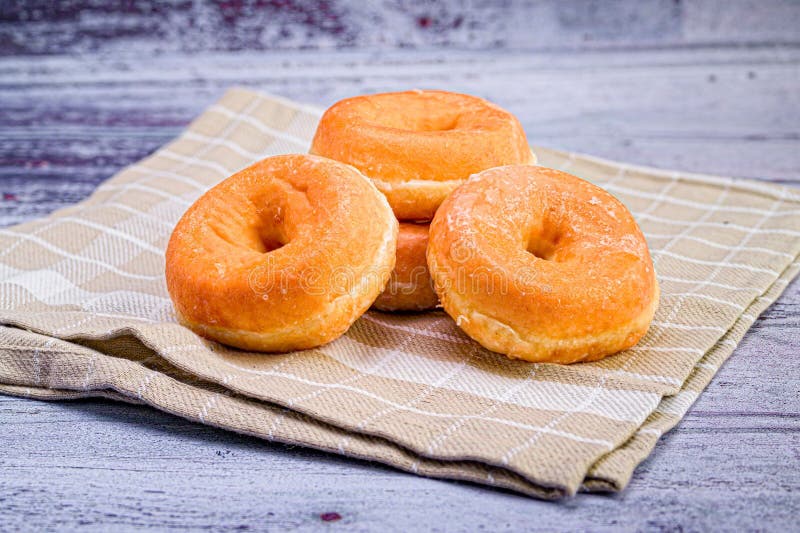 Delicious Assorted Donuts on a Rustic Napkin on a Wooden Table Stock ...