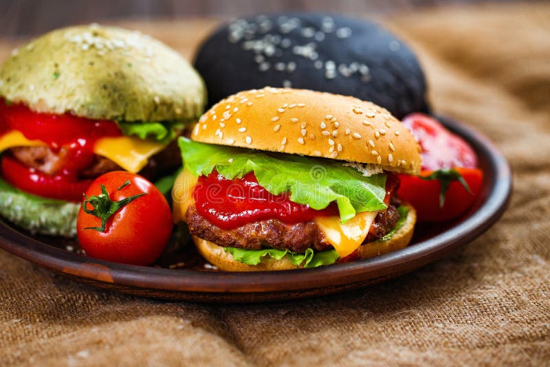 Three delicious burgers stock photo. Image of cuisine - 110155104